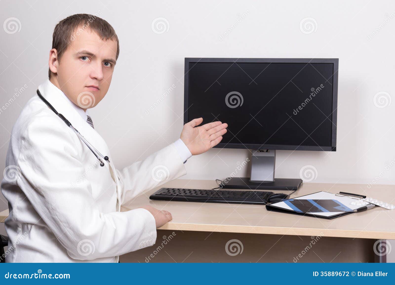 Young Male Doctor Pointing at Computer Screen Stock Photo - Image of ...