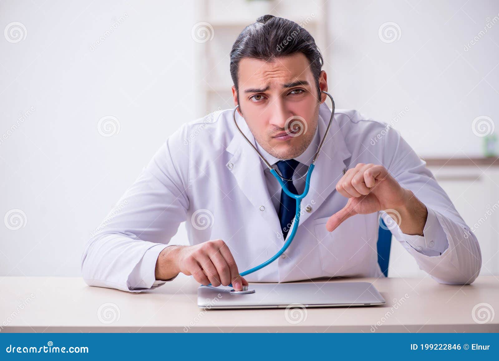 Young Male Doctor with Stethoscope Repairing Computer Stock Photo ...