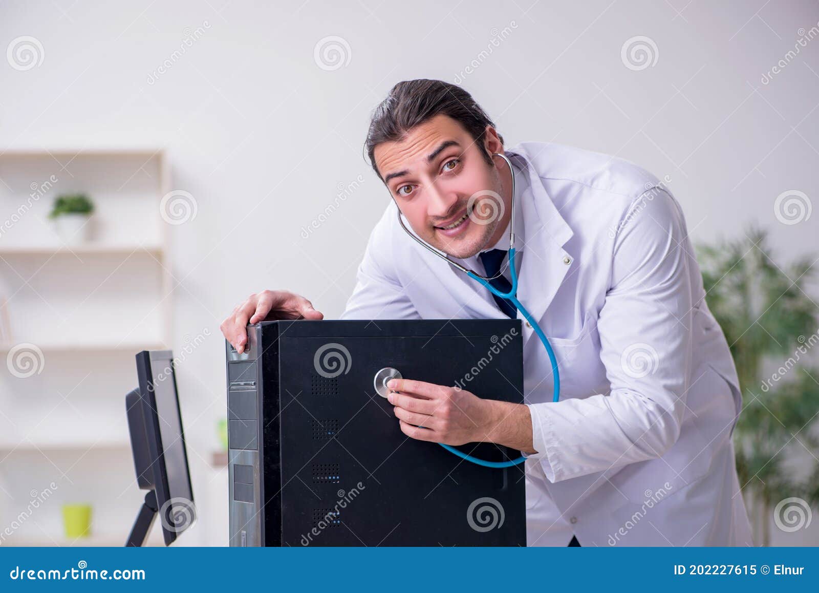 Young Male Doctor with Stethoscope Repairing Computer Stock Image ...