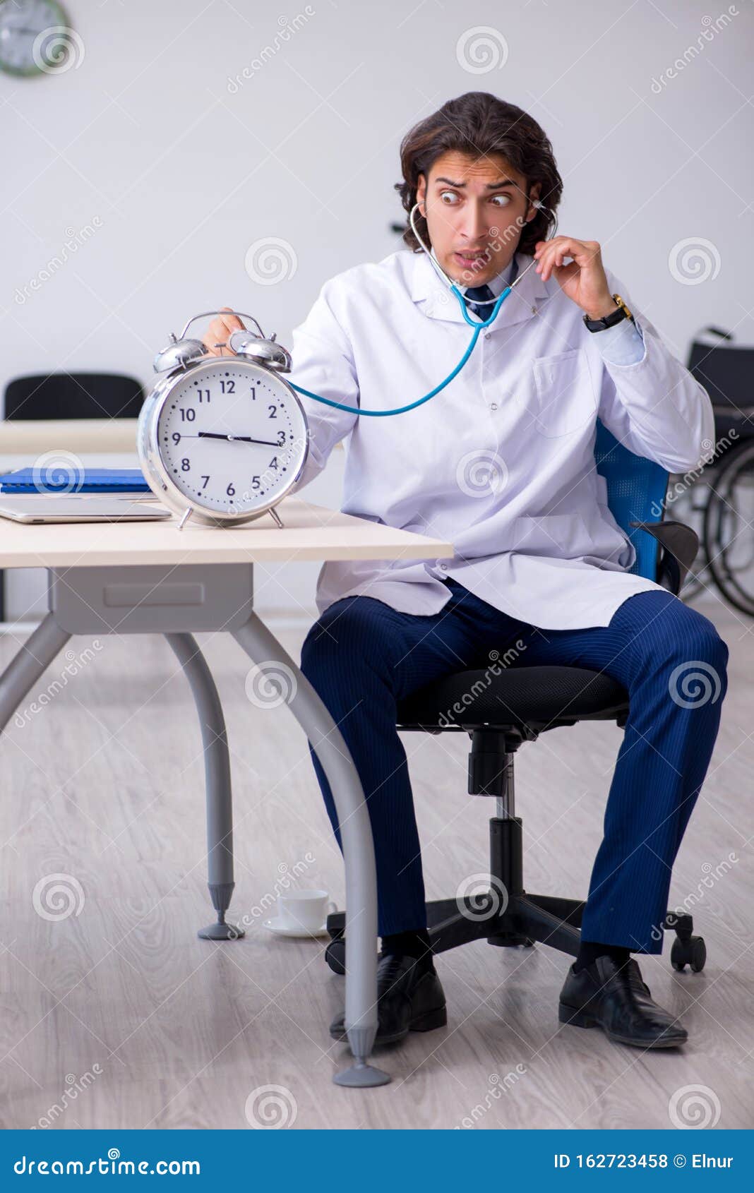 Young Male Doctor in Time Management Concept Stock Photo - Image of ...
