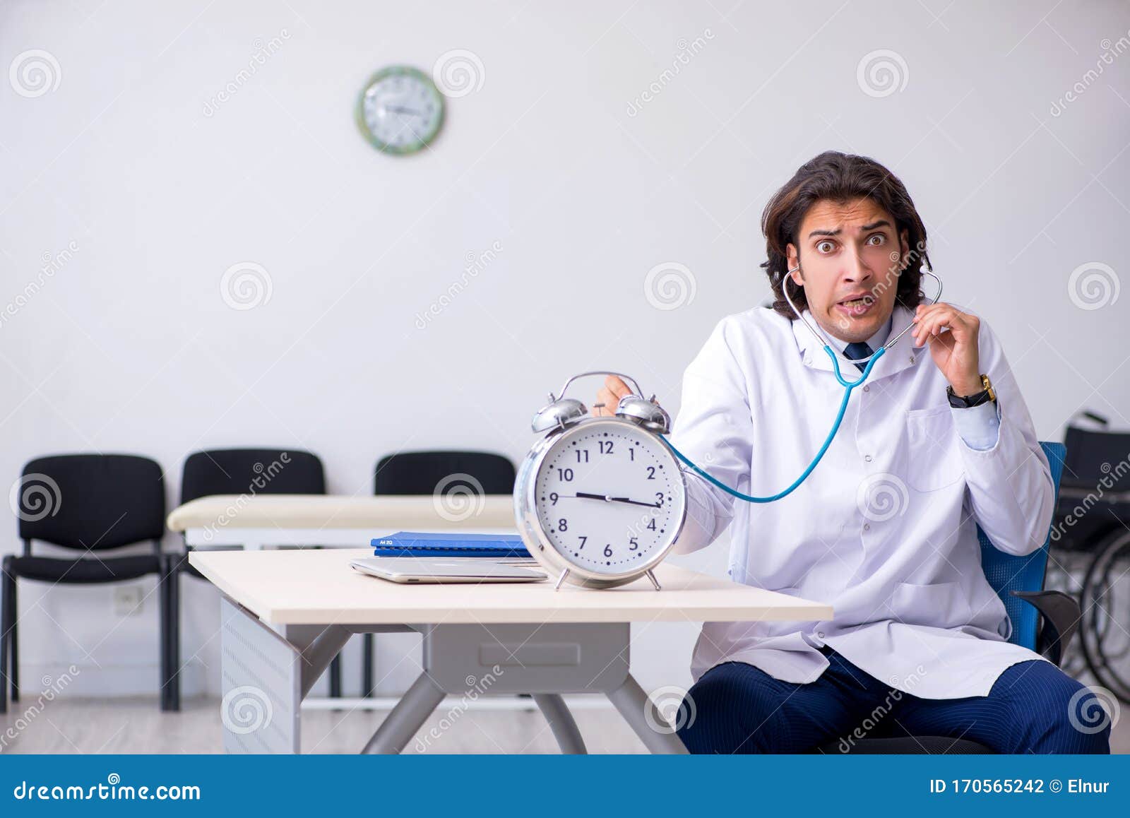 Young Male Doctor in Time Management Concept Stock Photo - Image of ...