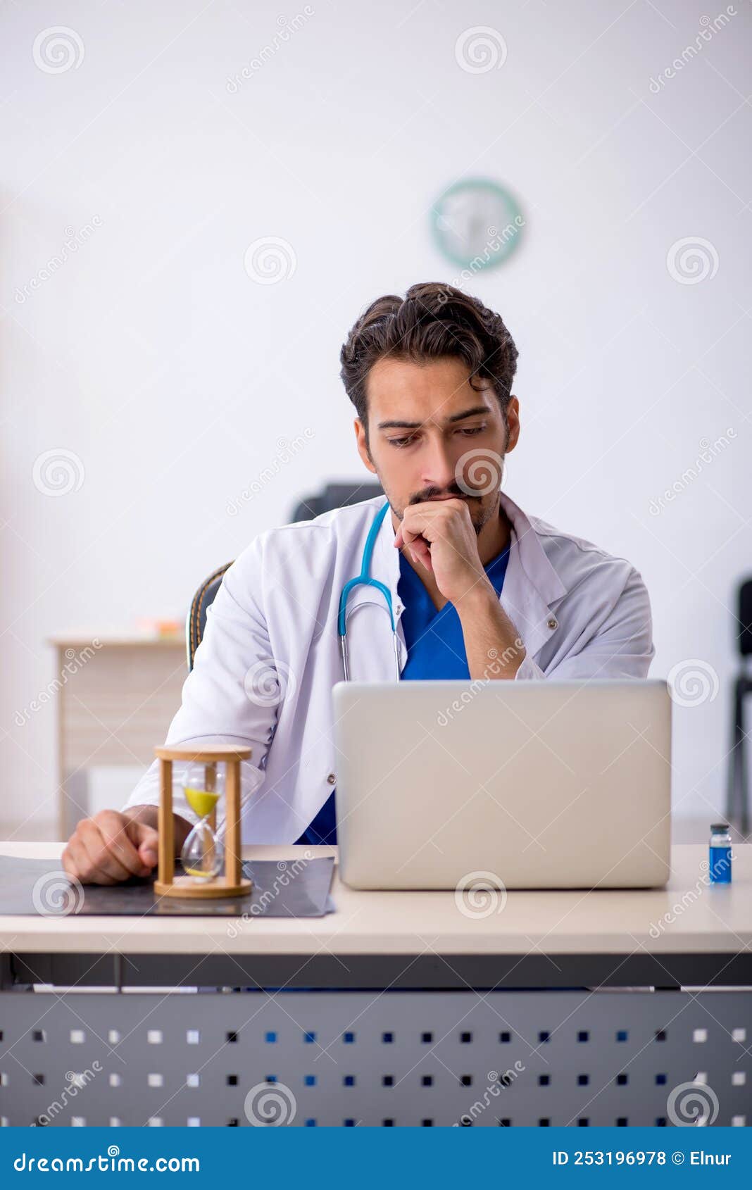 Young Male Doctor in Time Management Concept Stock Photo - Image of ...