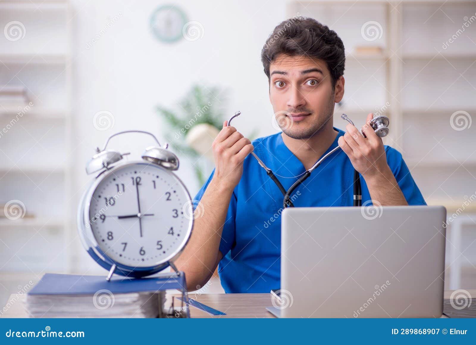 Young Male Doctor in Time Management Concept Stock Image - Image of ...