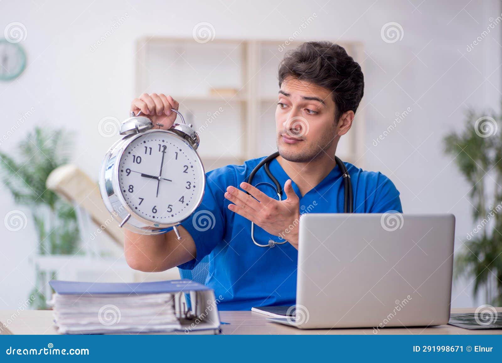 Young Male Doctor in Time Management Concept Stock Image - Image of ...
