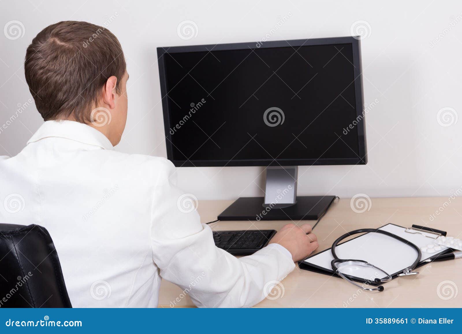 Young Male Doctor Using Personal Computer in Office Stock Image - Image ...