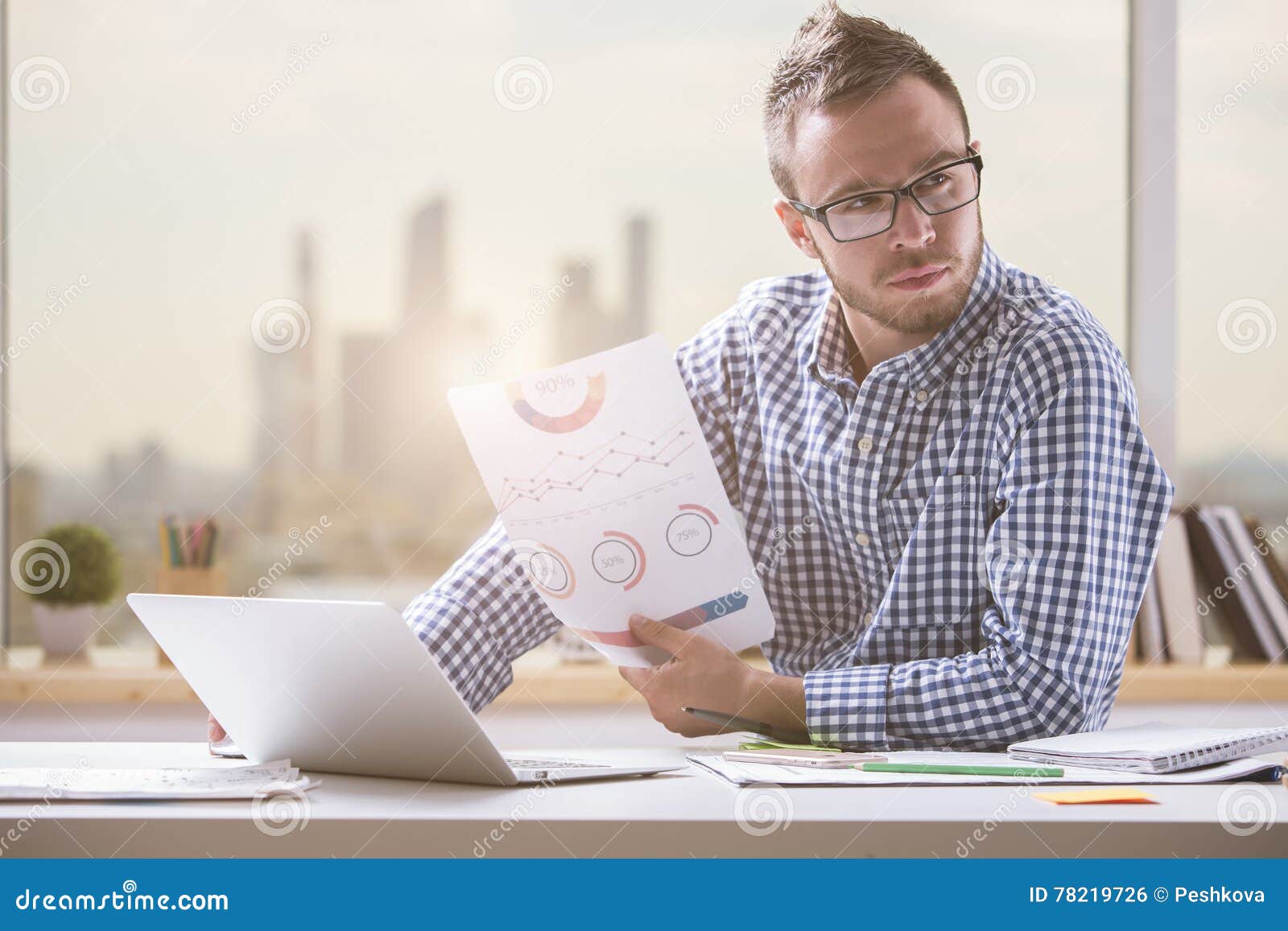 Young male doing paperwork stock photo. Image of laptop - 78219726