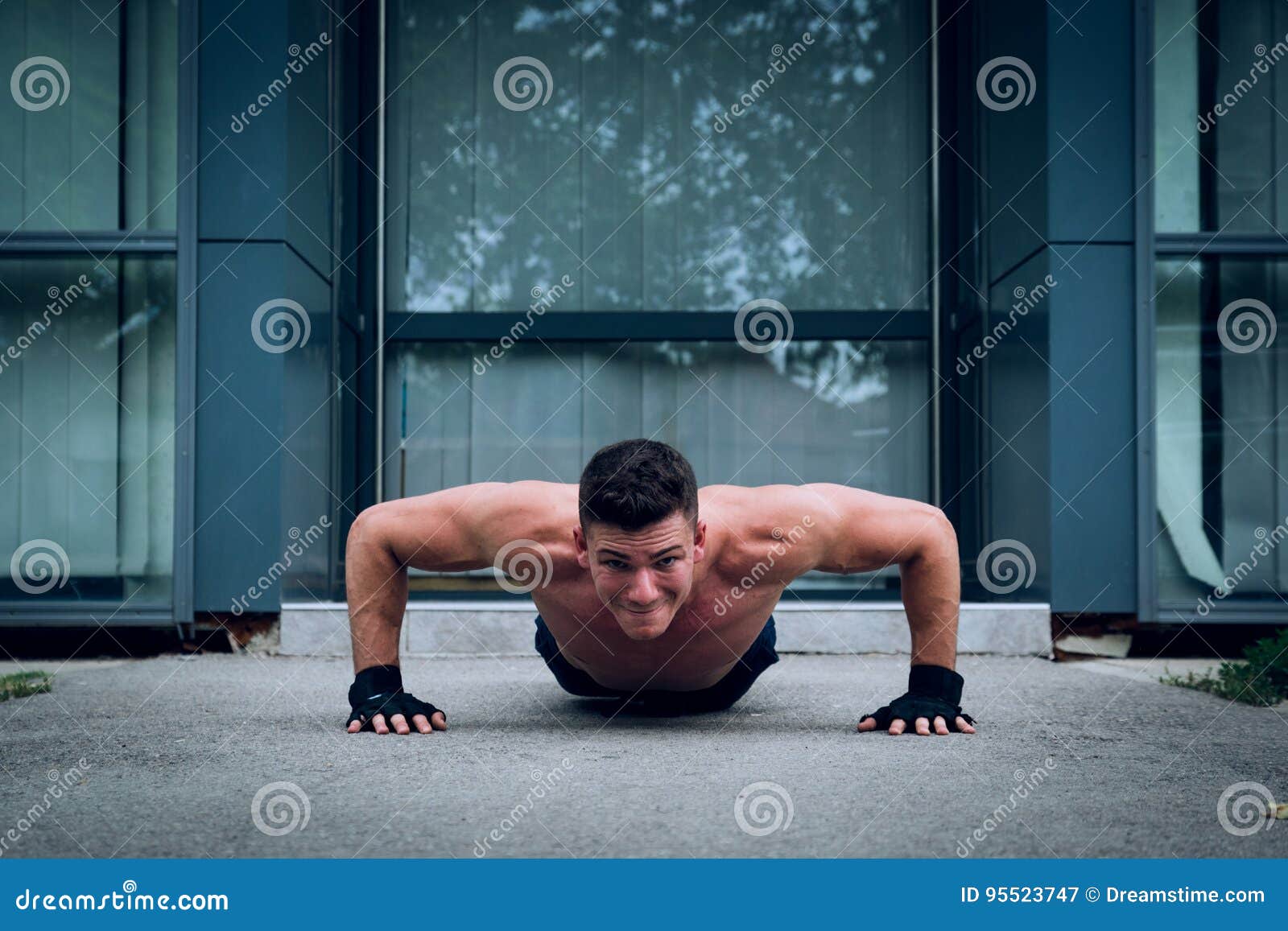 Young Male Doing Push Ups in Front of the Modern Sport Center. S Stock ...