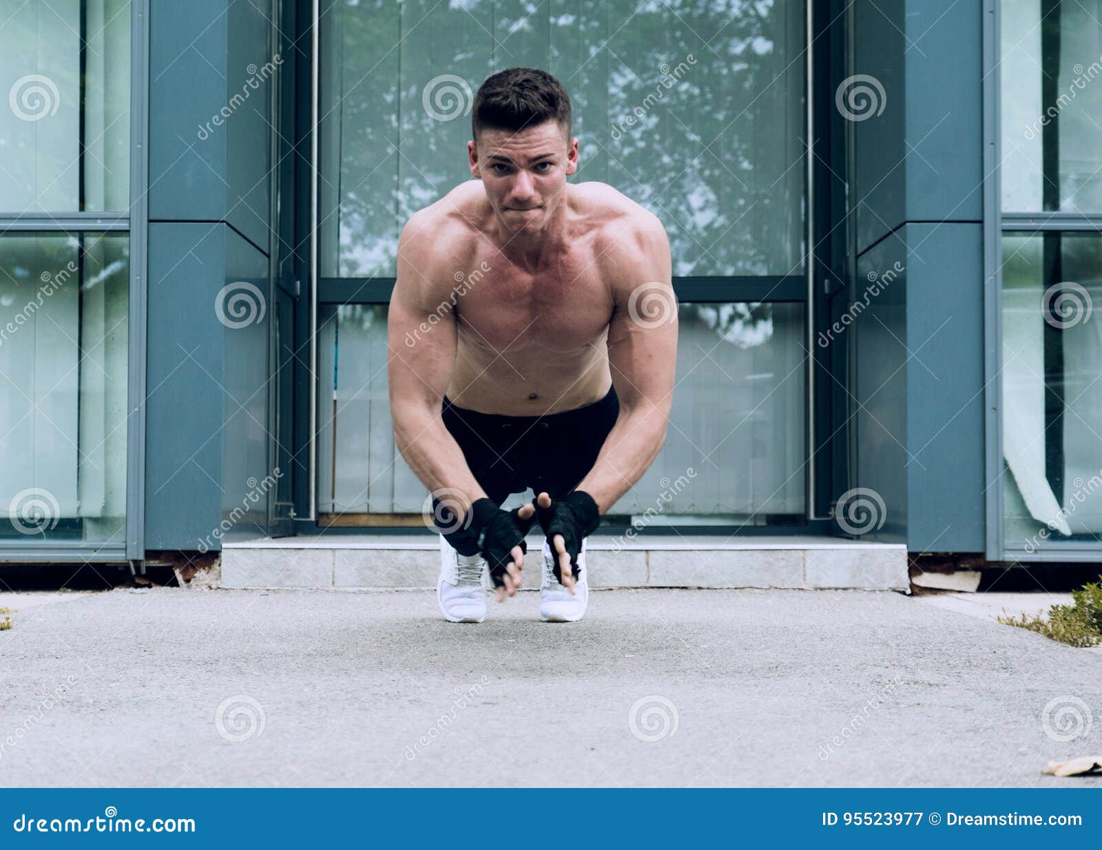 Young Male Doing Push Ups in Front of the Modern Sport Center. S Stock ...