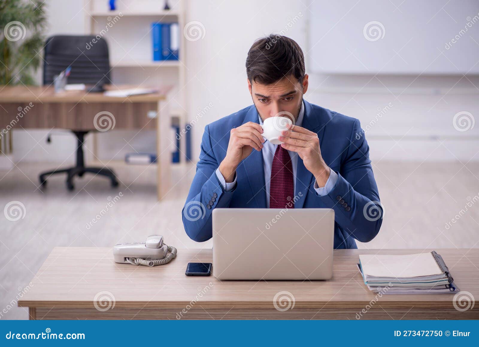 Young Male Employee Drinking Coffee in the Office Stock Photo - Image ...