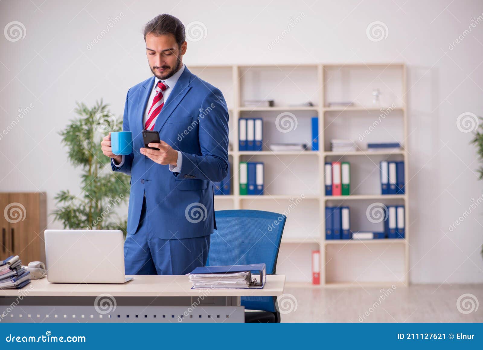 Young Male Employee Drinking Coffee at Workplace Stock Image - Image of ...