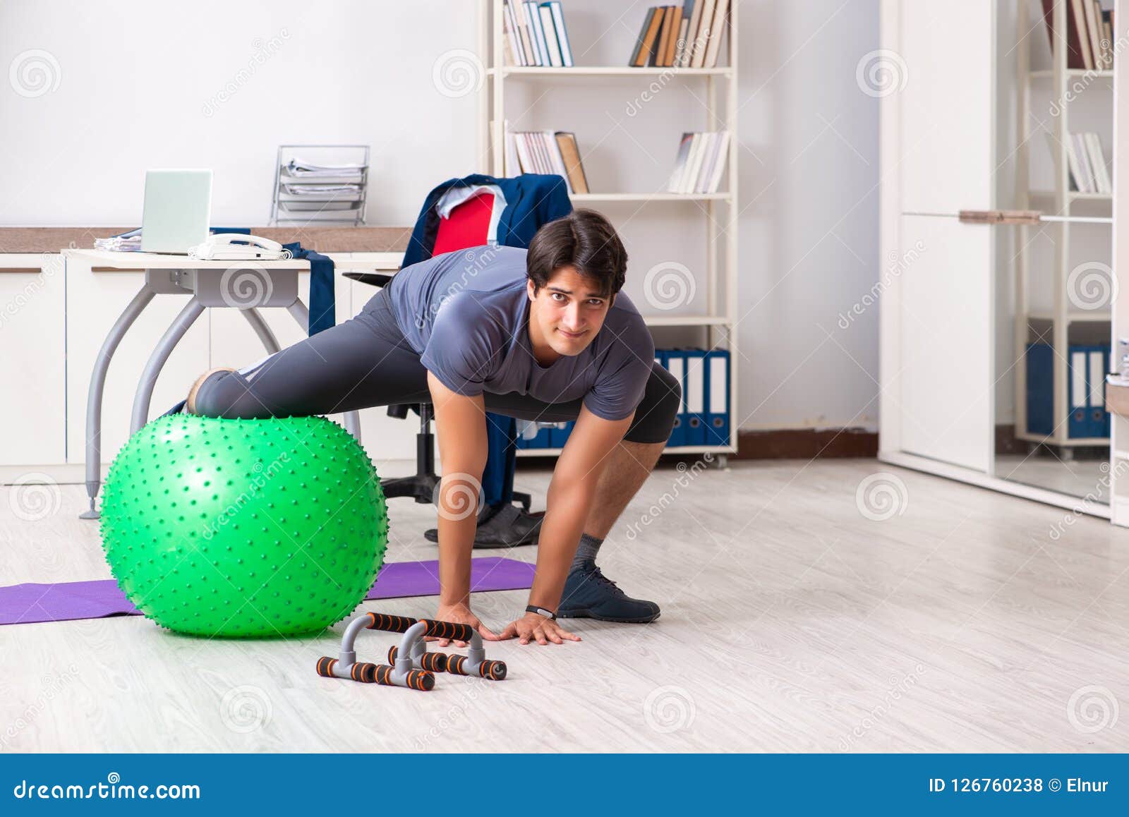 The Young Male Employee Exercising in the Office Stock Photo - Image of ...