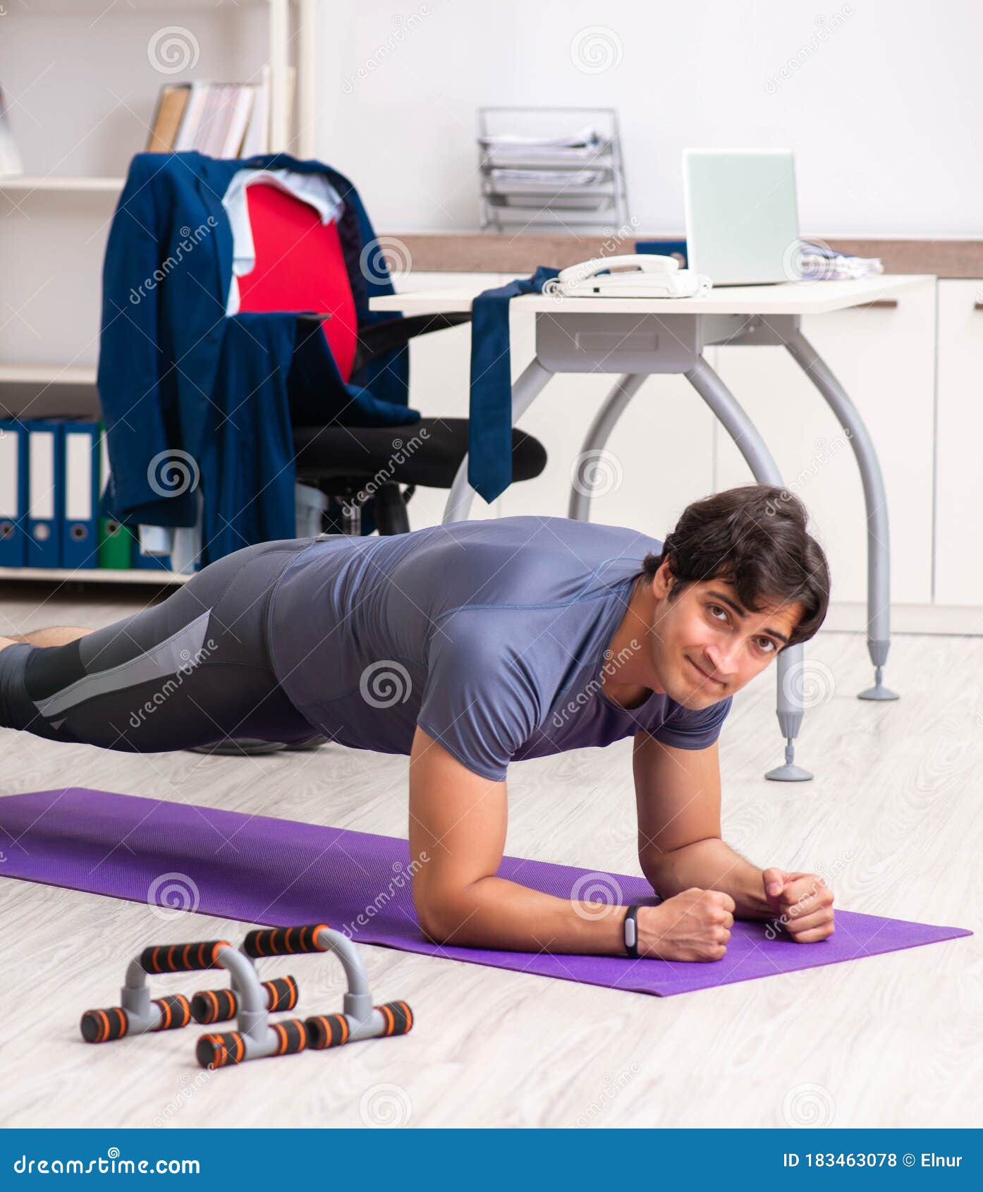 Young Male Employee Exercising in the Office Stock Photo - Image of ...