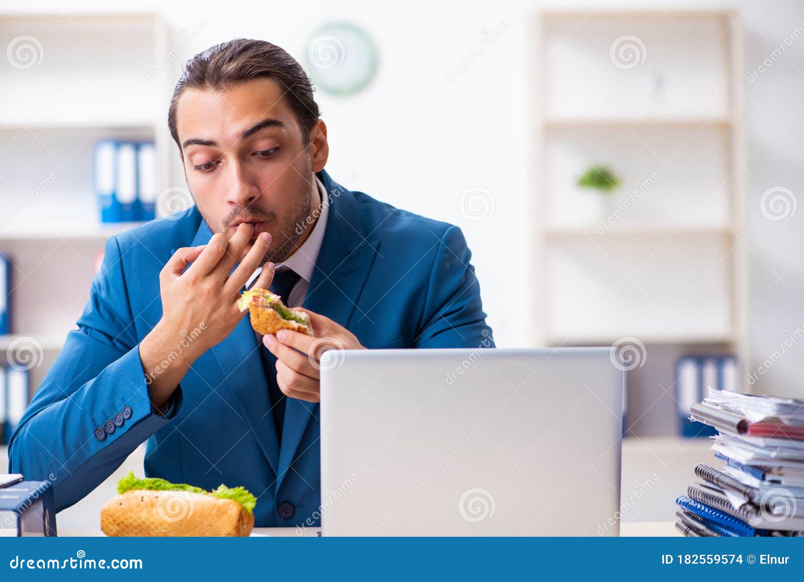 Young Male Employee Having Breakfast at Workplace Stock Photo - Image ...