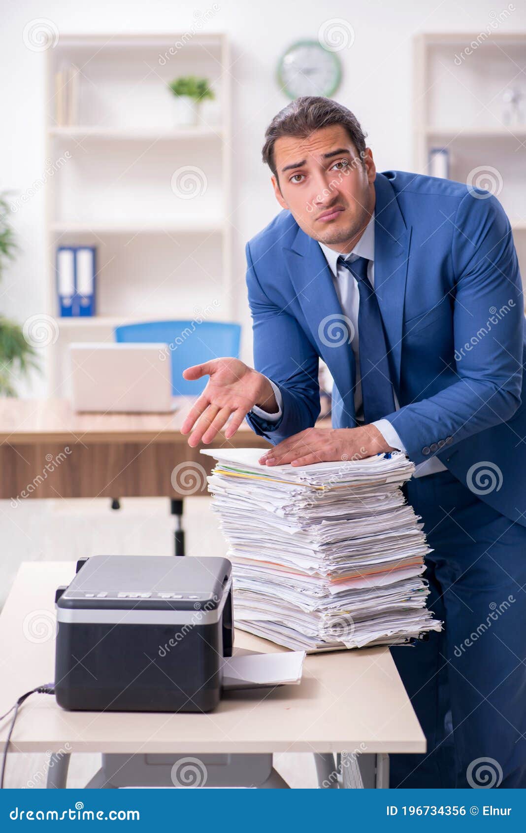 Young Male Employee Making Copies at Copying Machine Stock Photo ...