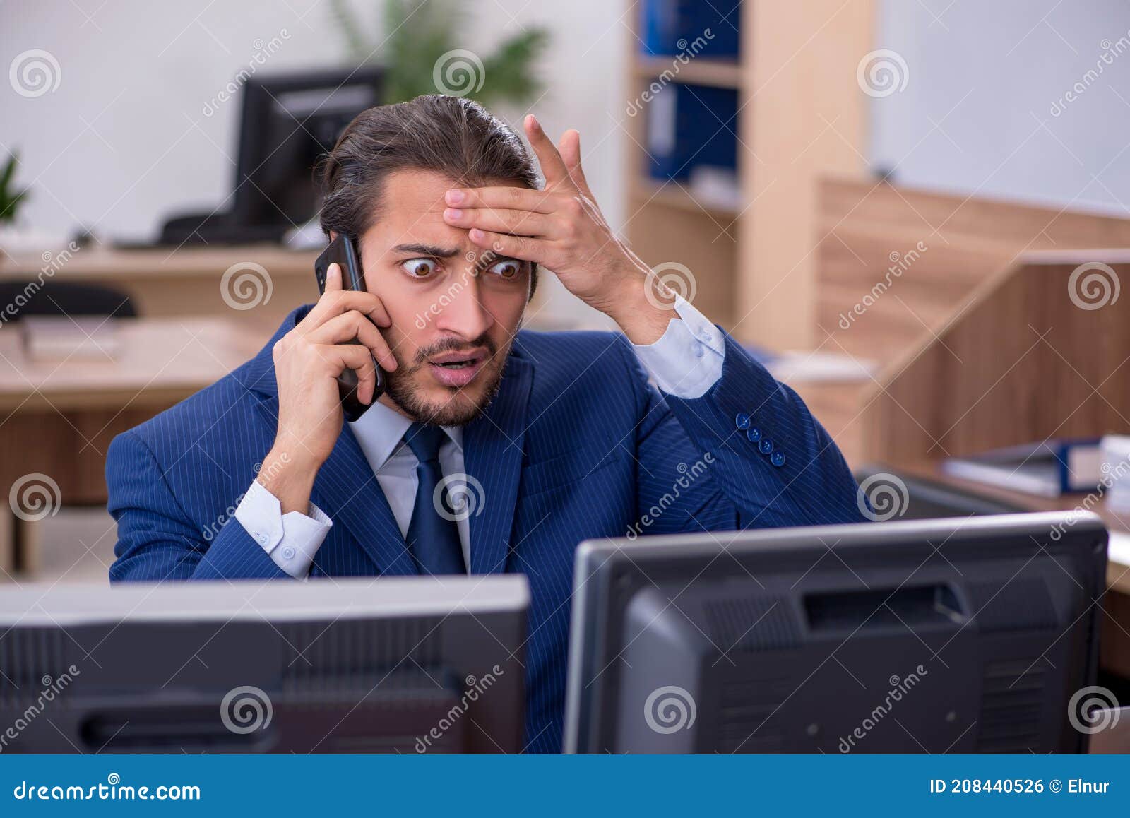 Young Male Employee in Multitasking Concept Stock Photo - Image of ...