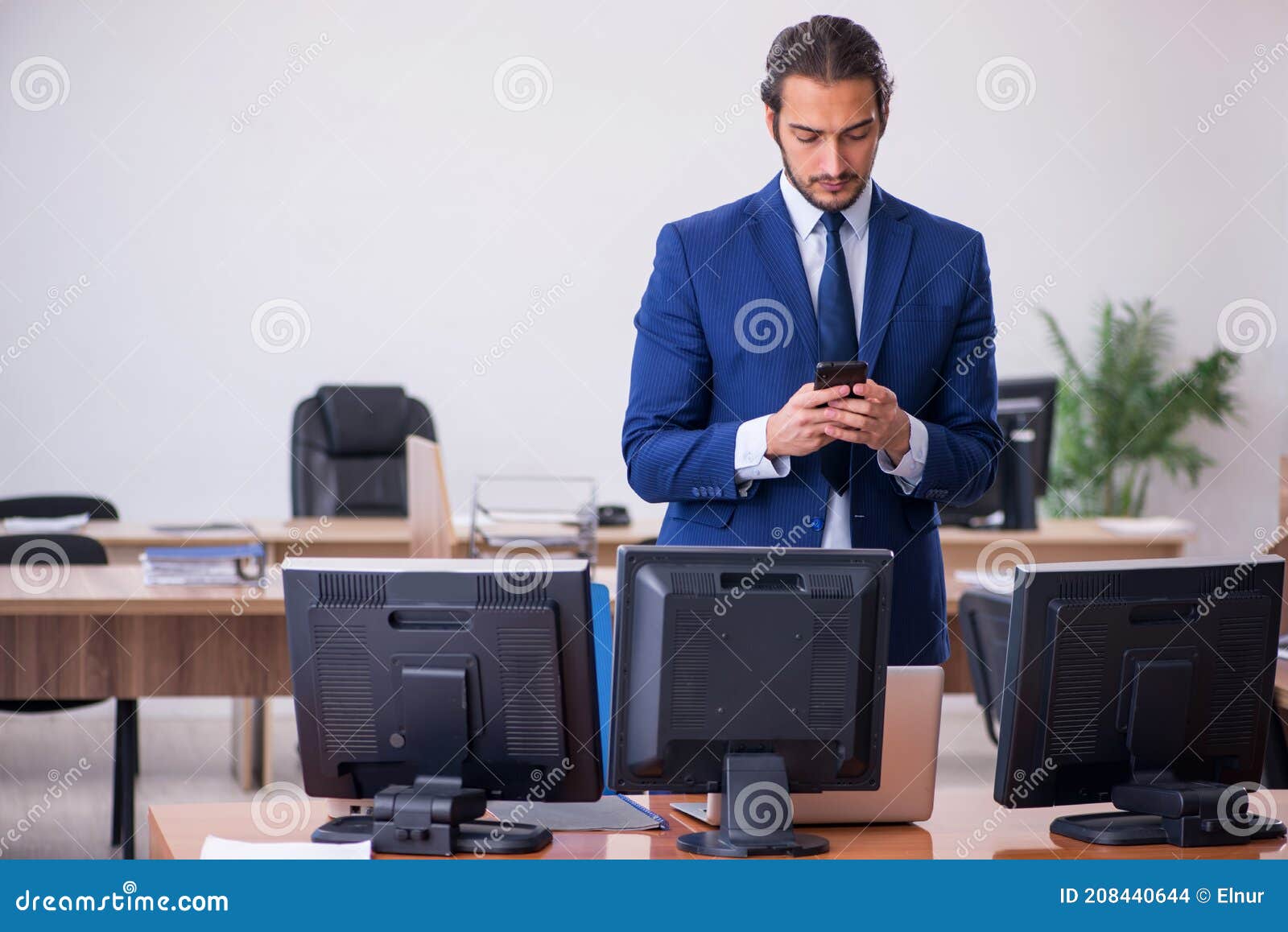 Young Male Employee in Multitasking Concept Stock Photo - Image of ...