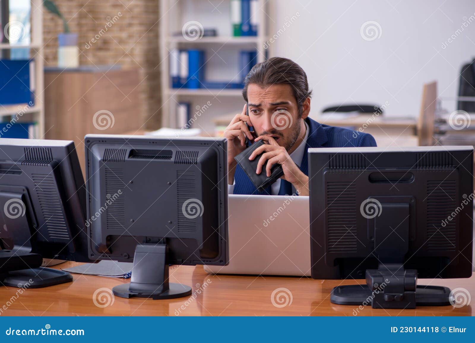 Young Male Employee in Multitasking Concept Stock Photo - Image of ...