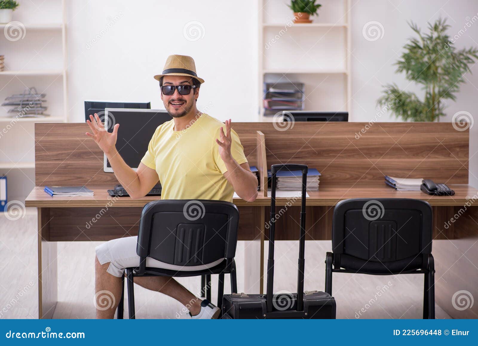Young Male Employee Preparing for Trip at Workplace Stock Photo - Image ...