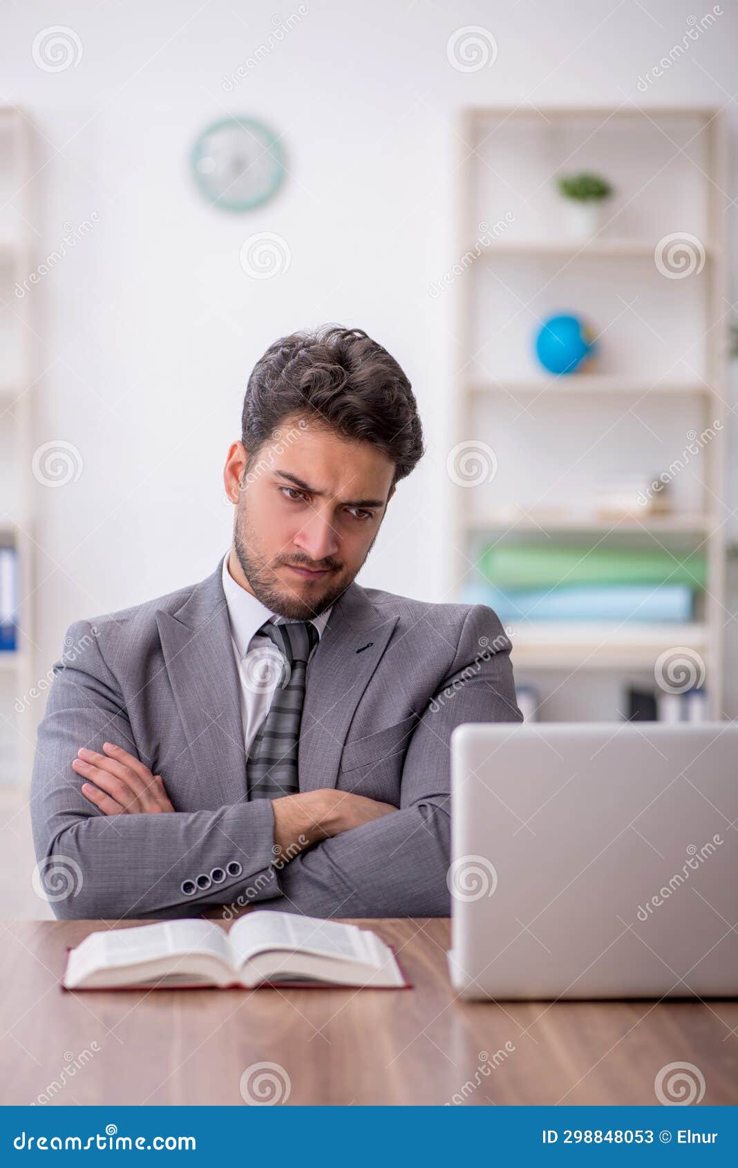 Young Male Employee Reading Book in the Office Stock Image - Image of ...