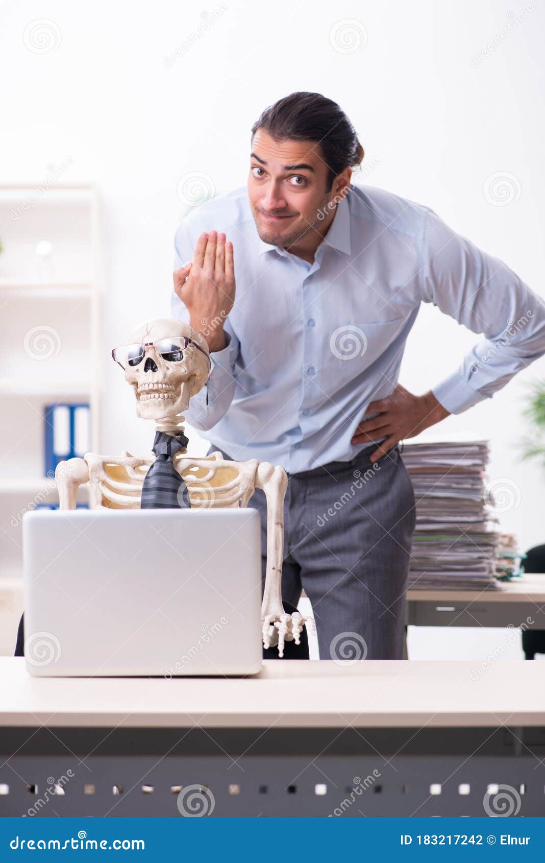 Young Male Employee and Skeleton in the Office Stock Photo - Image of ...