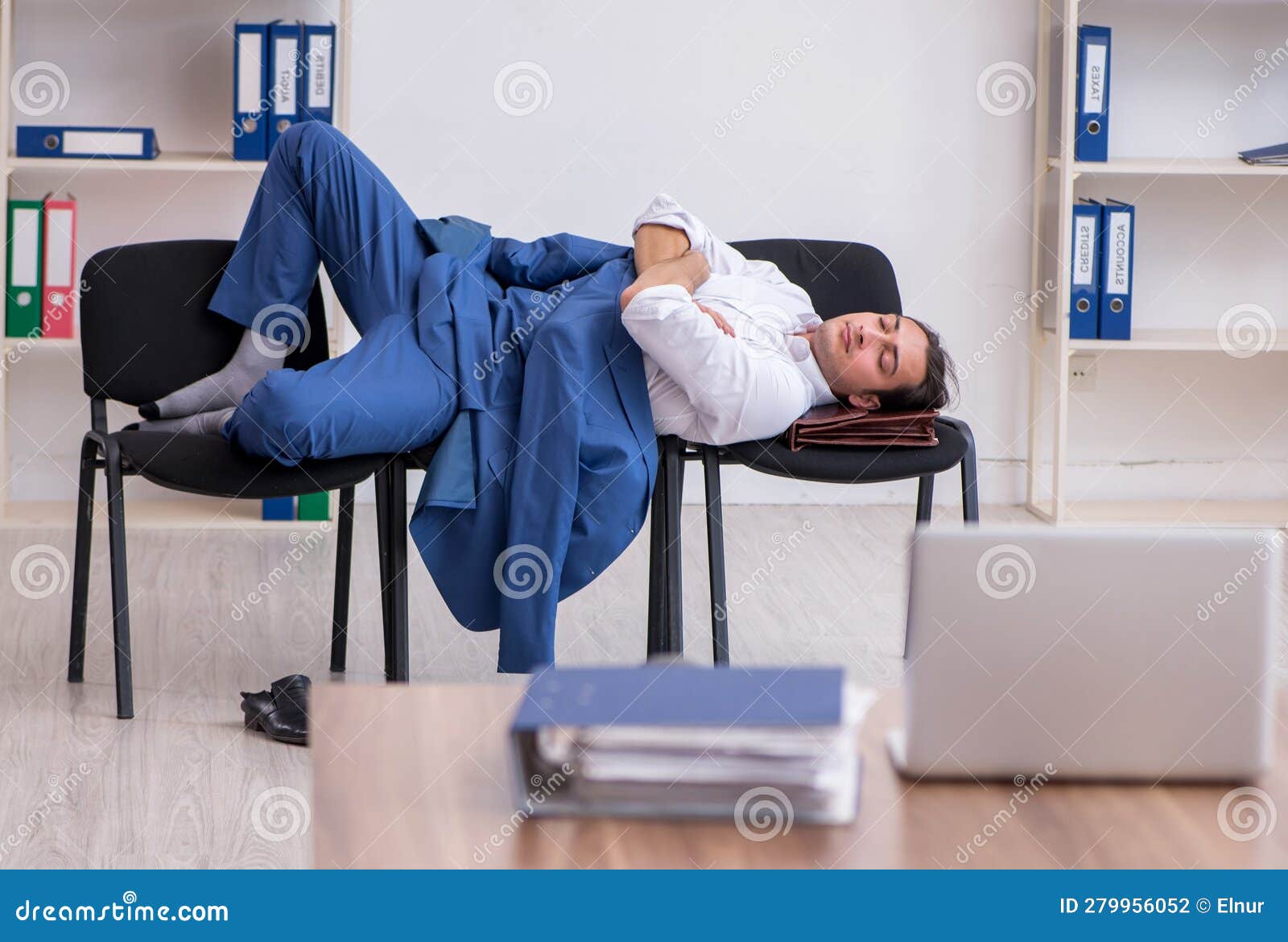 Young Male Employee Sleeping in the Office on Chairs Stock Photo ...