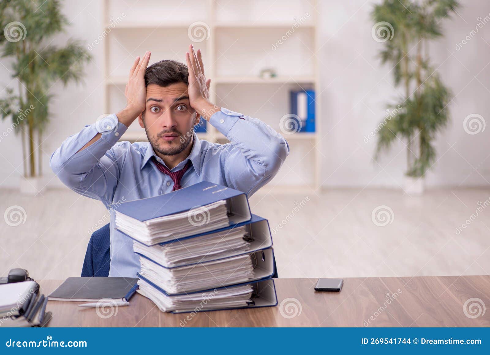 Young Male Employee and Too Much Work in the Office Stock Photo - Image ...