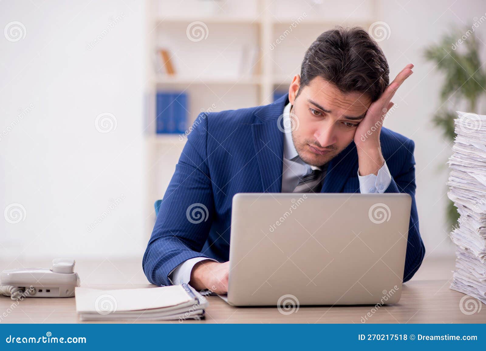 Young Male Employee and Too Much Work in the Office Stock Photo - Image ...