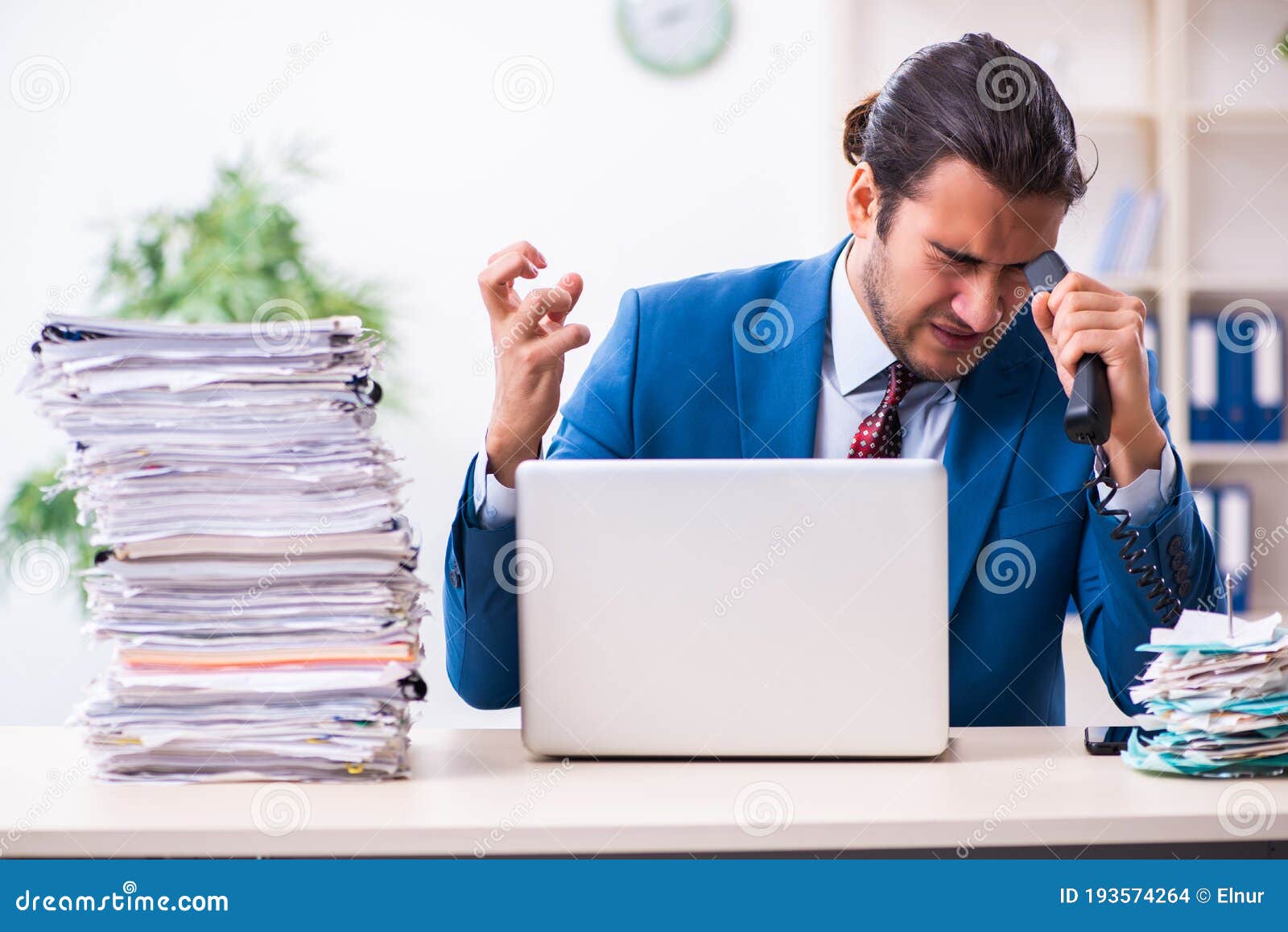 Young Male Employee Unhappy with Excessive Work Stock Photo - Image of ... Young Male Employee Unhappy with Excessive Work Stock Photo - Image of ...