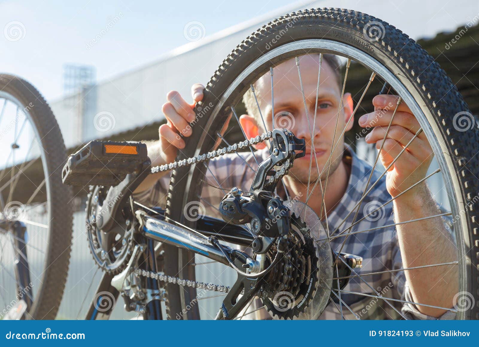 A Young Male Engineer Master is Looking at a Bicycle Wheel Stock Image ...