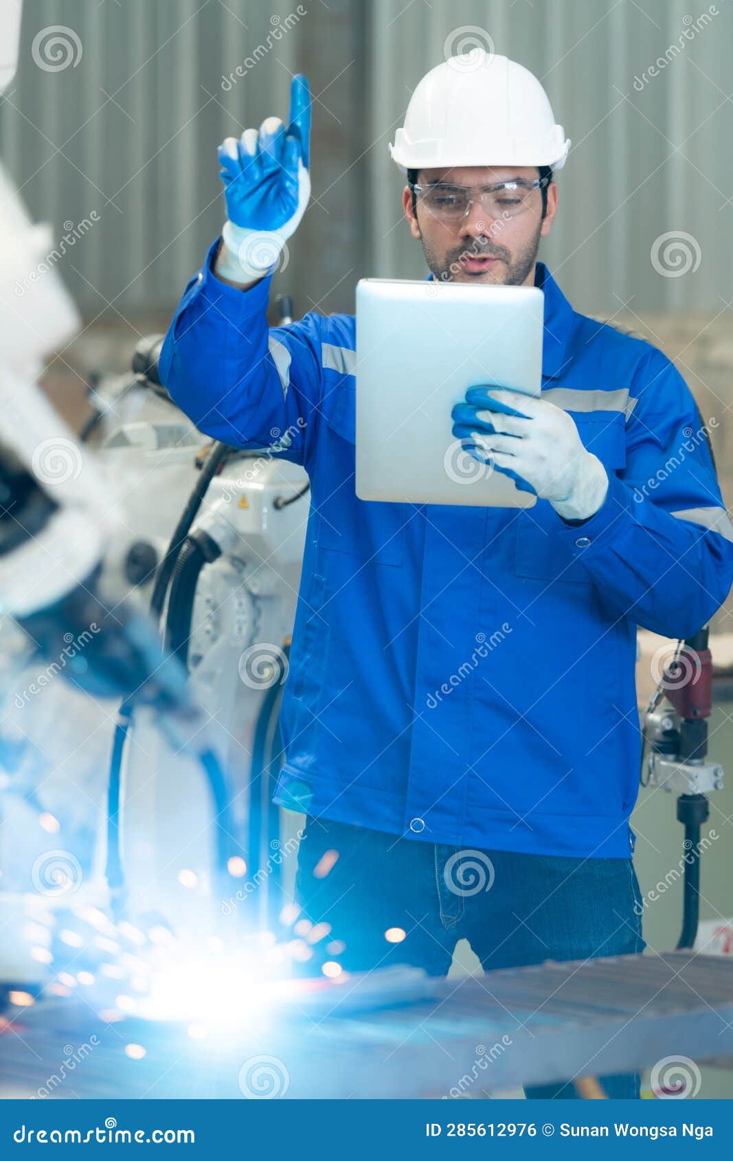Young Male Engineers are Manipulating a Welding Robot Hand. by ...
