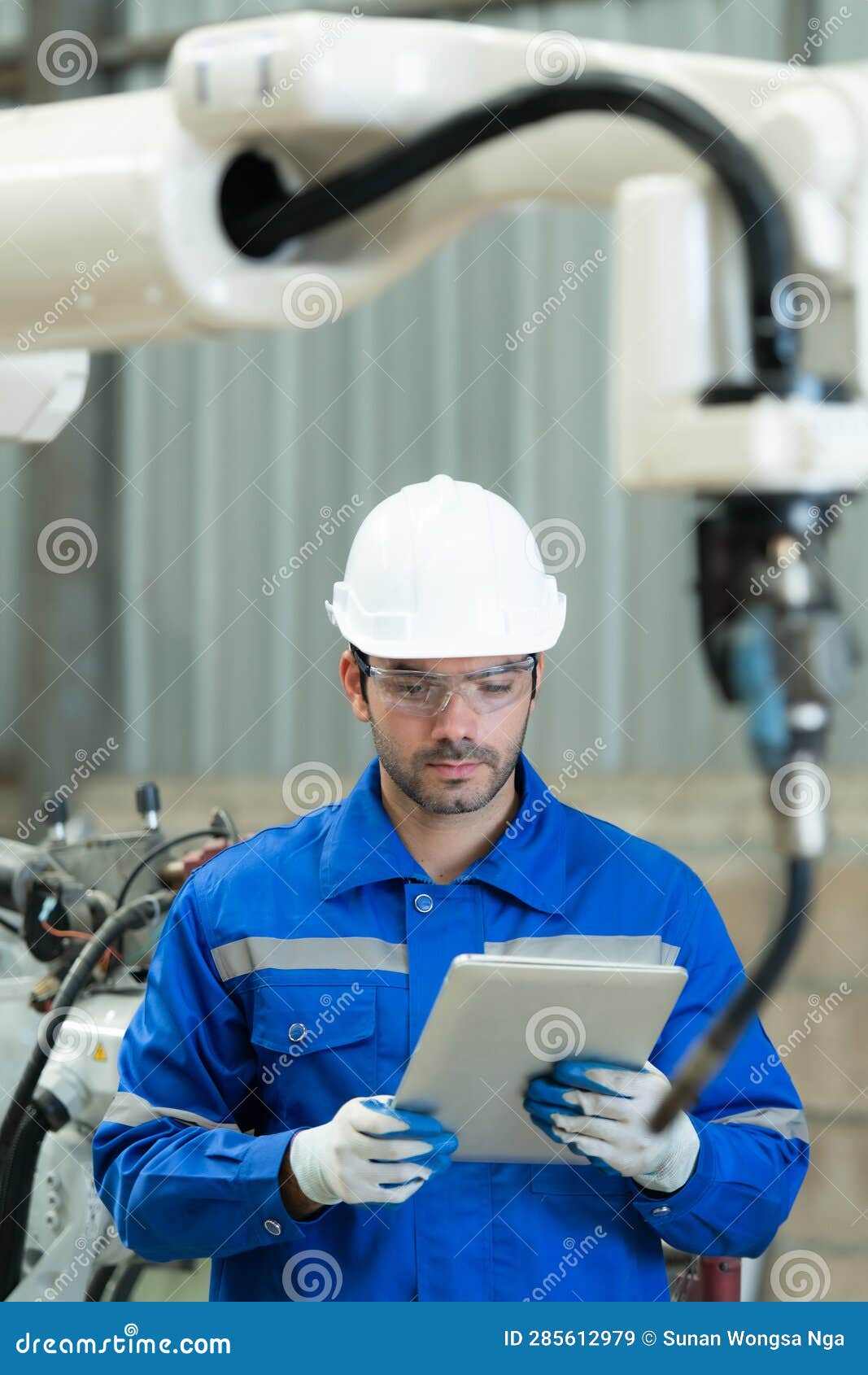 Young Male Engineers are Manipulating a Welding Robot Hand. by ...