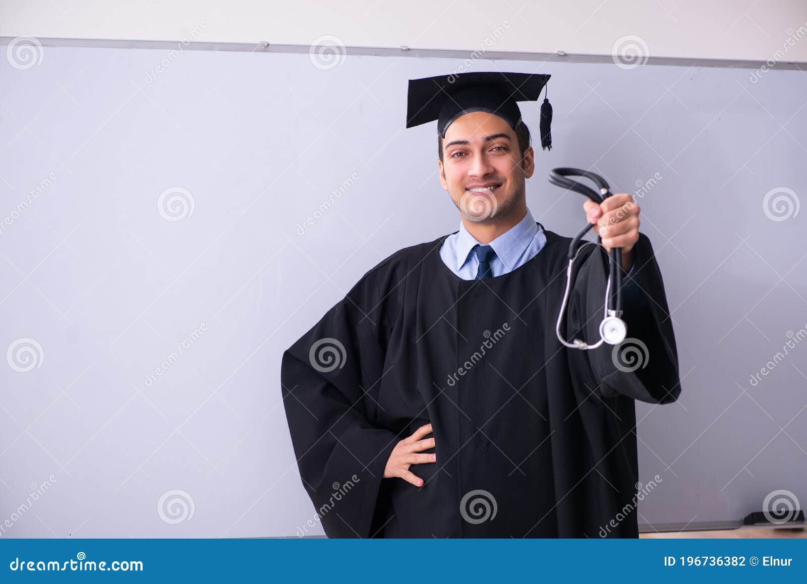 Young Male Graduate in Front of Board Stock Photo - Image of bachelor ...