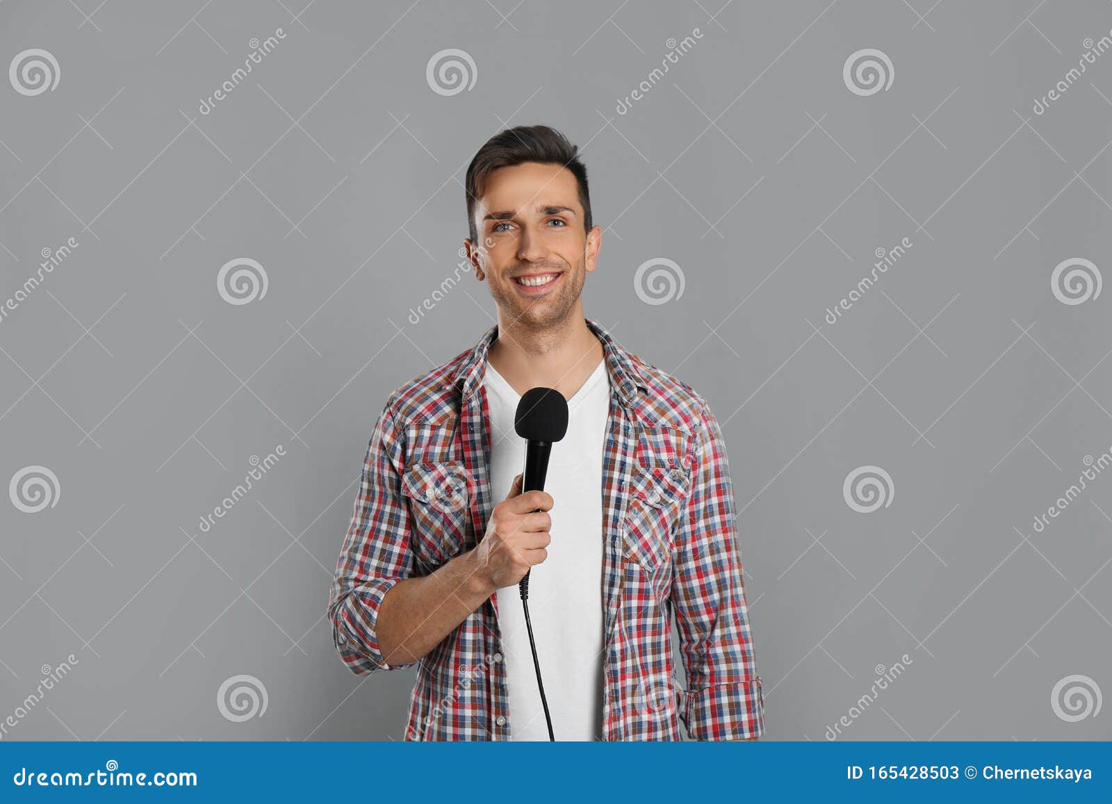 Young Male Journalist with Microphone on Background Stock Image - Image ...