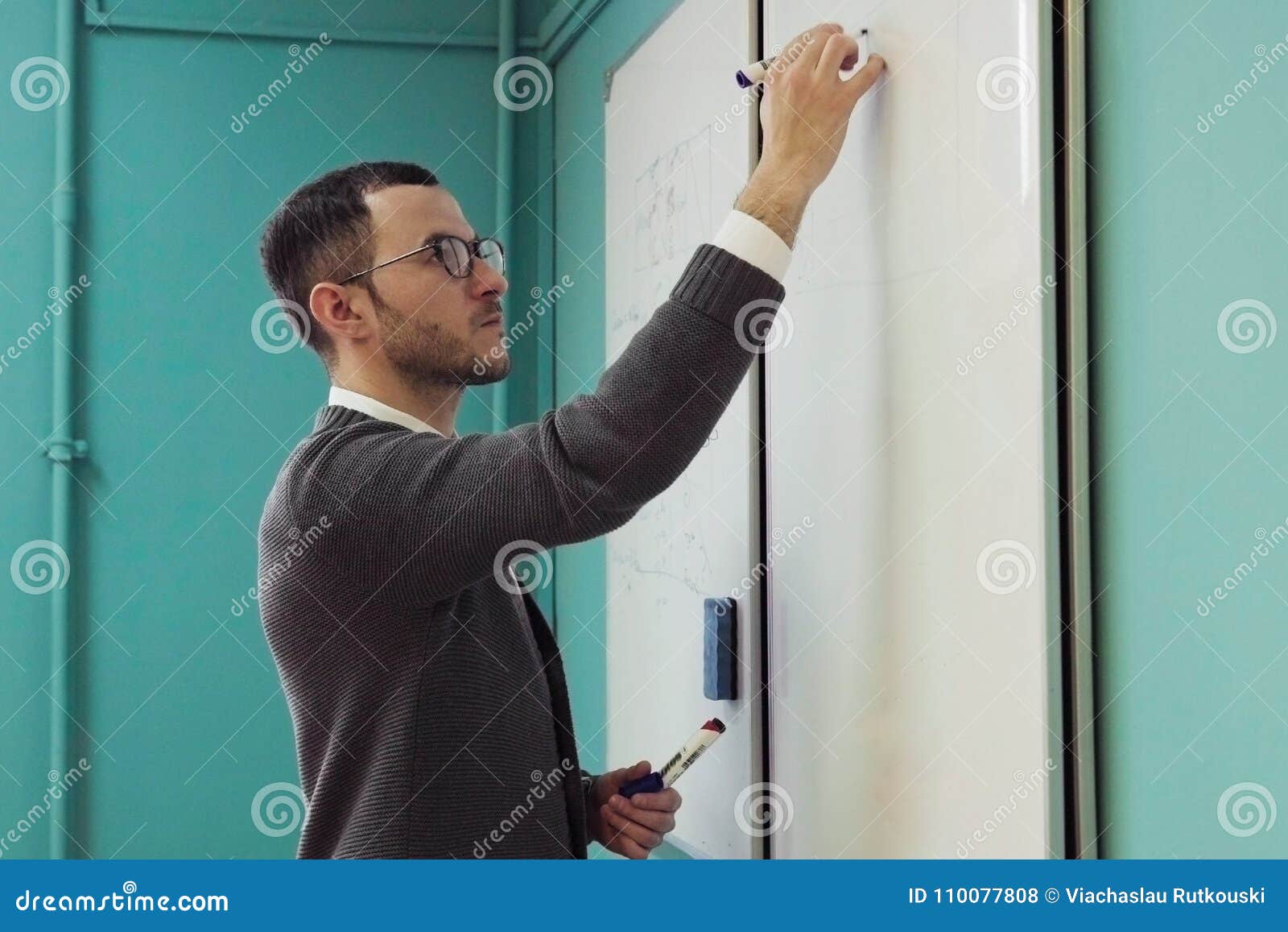 Young Male Lecturer Writes on Whiteboard in Classroom Stock Photo ...