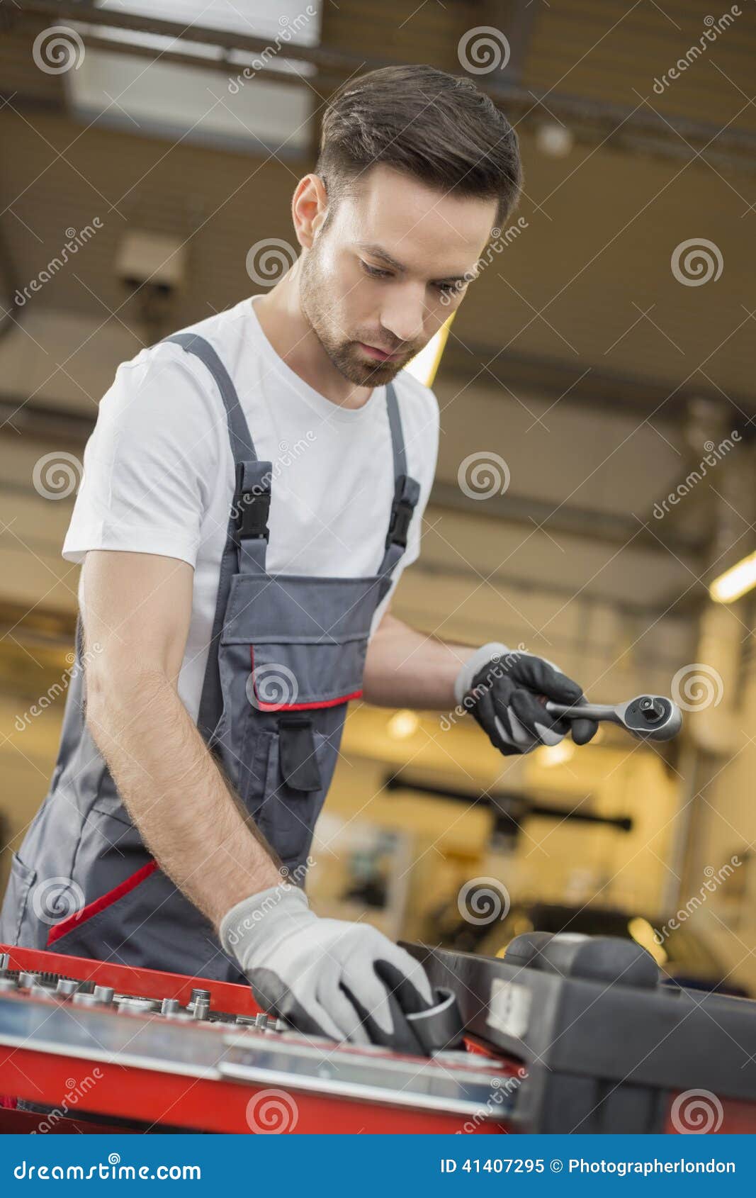 Young Male Maintenance Engineer Arranging Tools in Drawer at Car ...