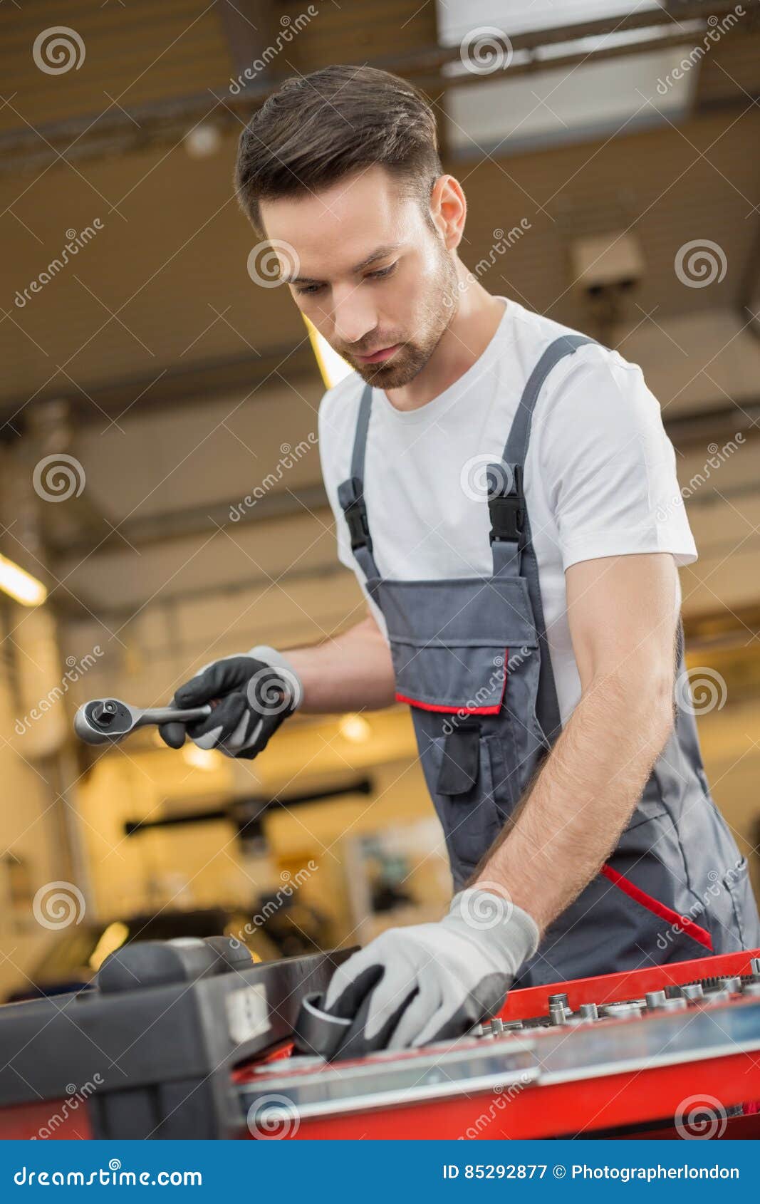 Young Male Maintenance Engineer Arranging Tools in Drawer at Car ...