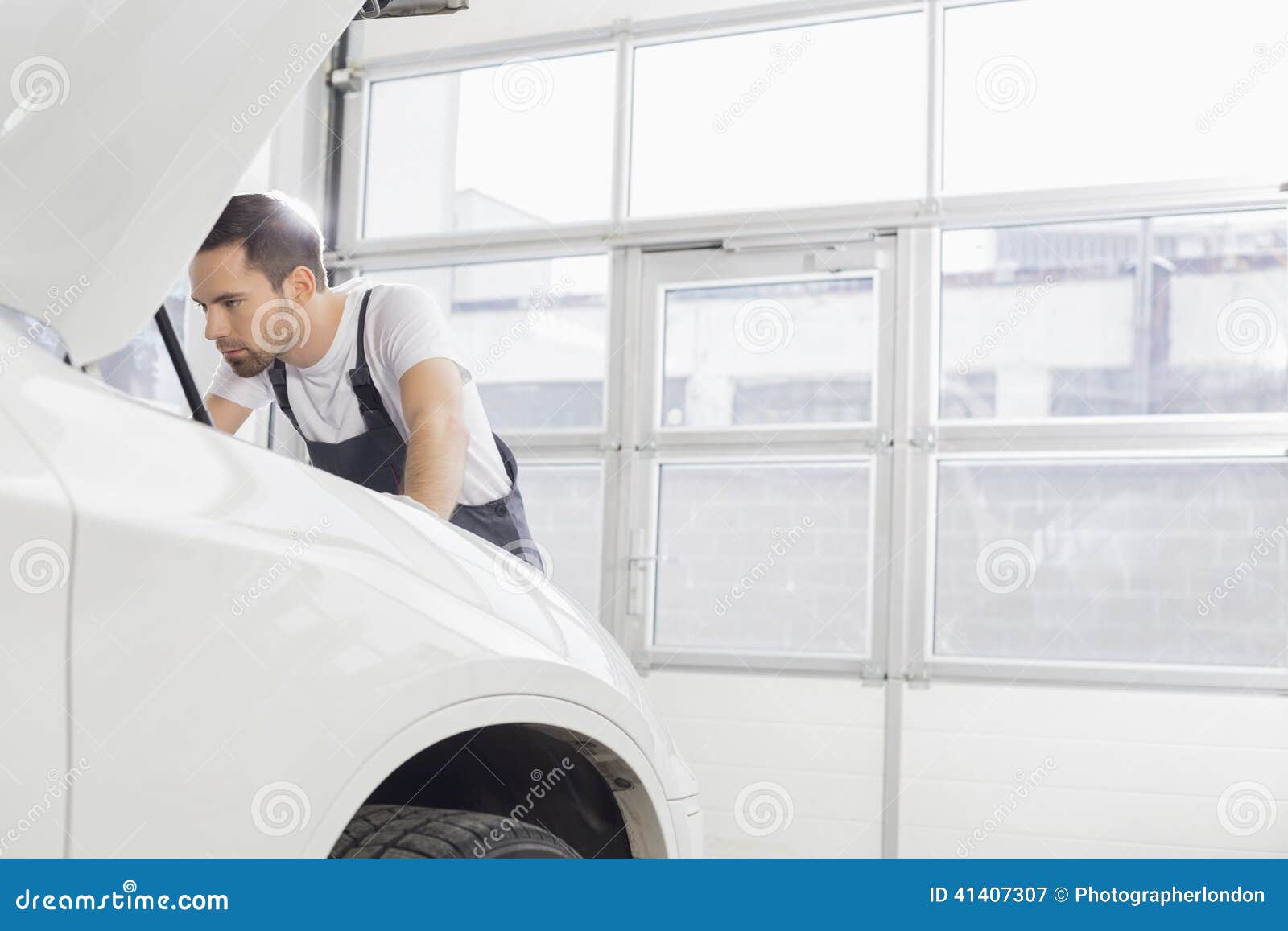 Young Male Maintenance Engineer Repairing Car Engine in Workshop Stock ...
