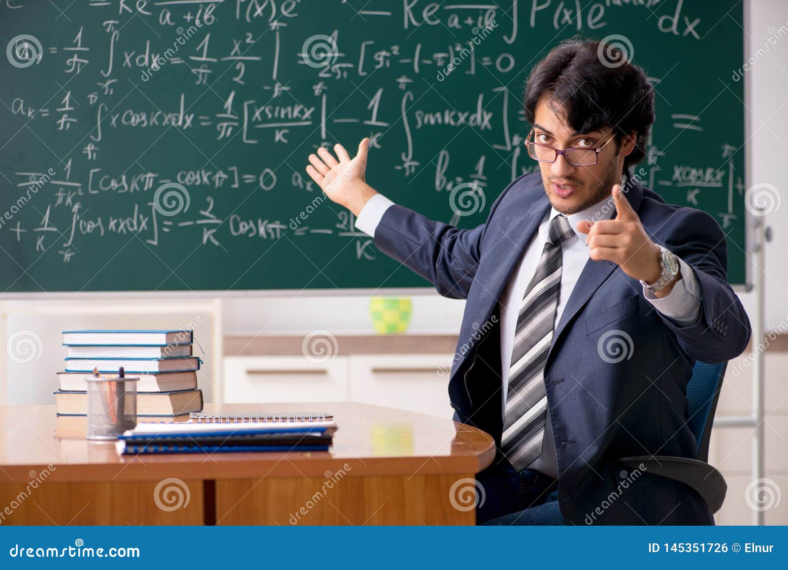 The Young Male Math Teacher in Classroom Stock Photo - Image of books ...