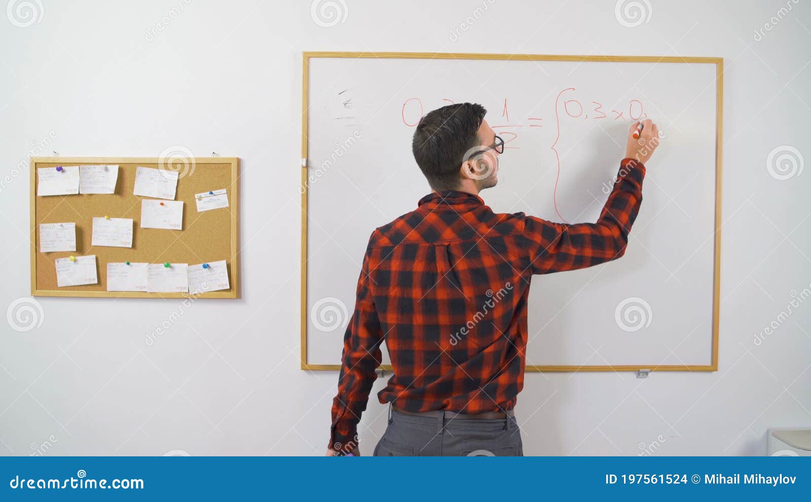 Young Male Math Teacher Writing Mathematical Equations on Whiteboard ...