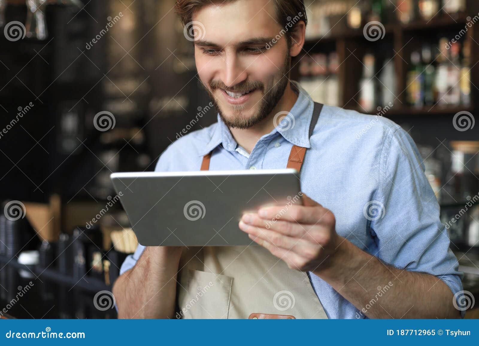 Young Male Owner Using Digital Tablet while Standing in Cafe Stock ...