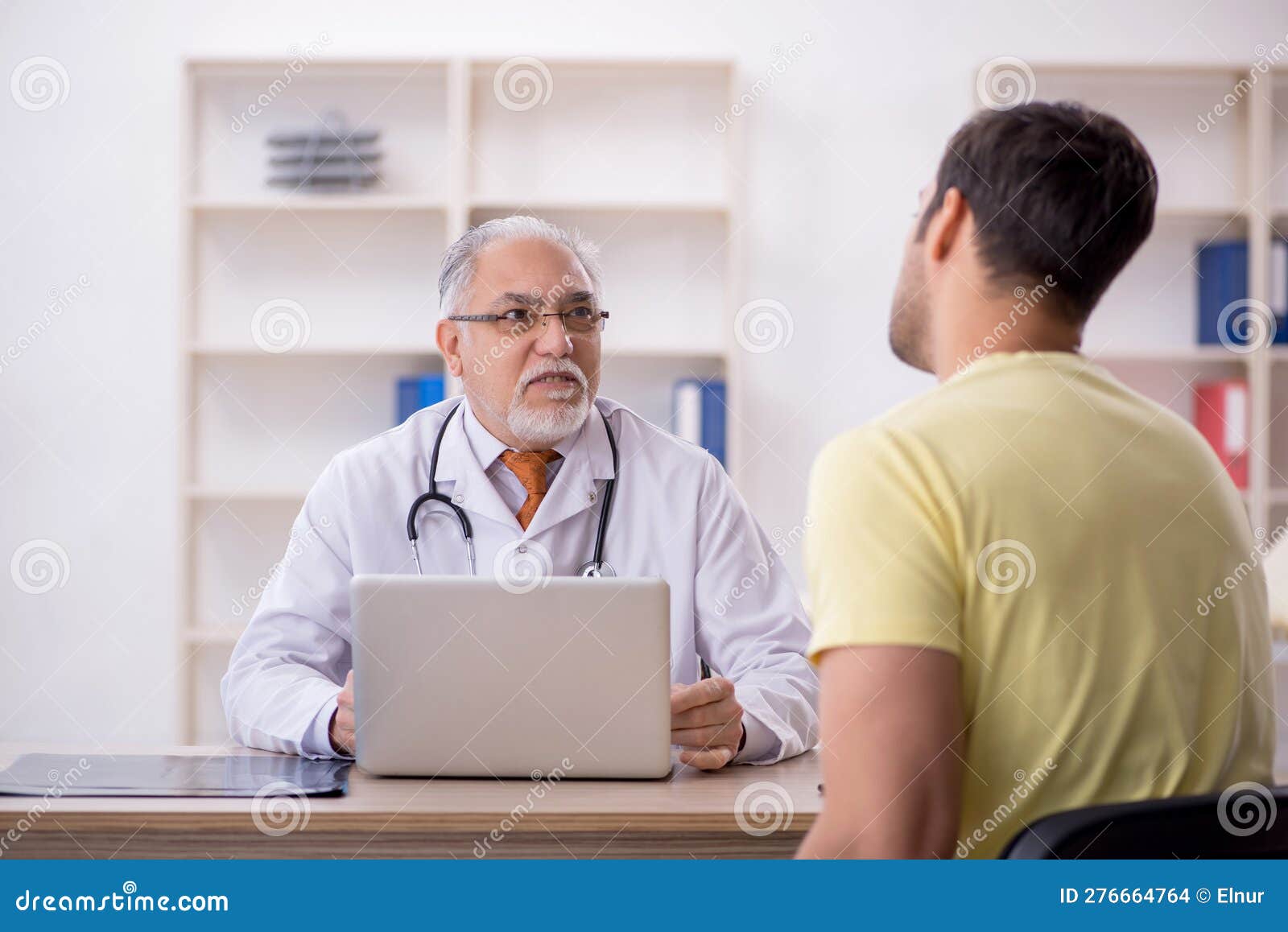 Young Male Patient Visiting Old Male Doctor Stock Photo - Image of ...
