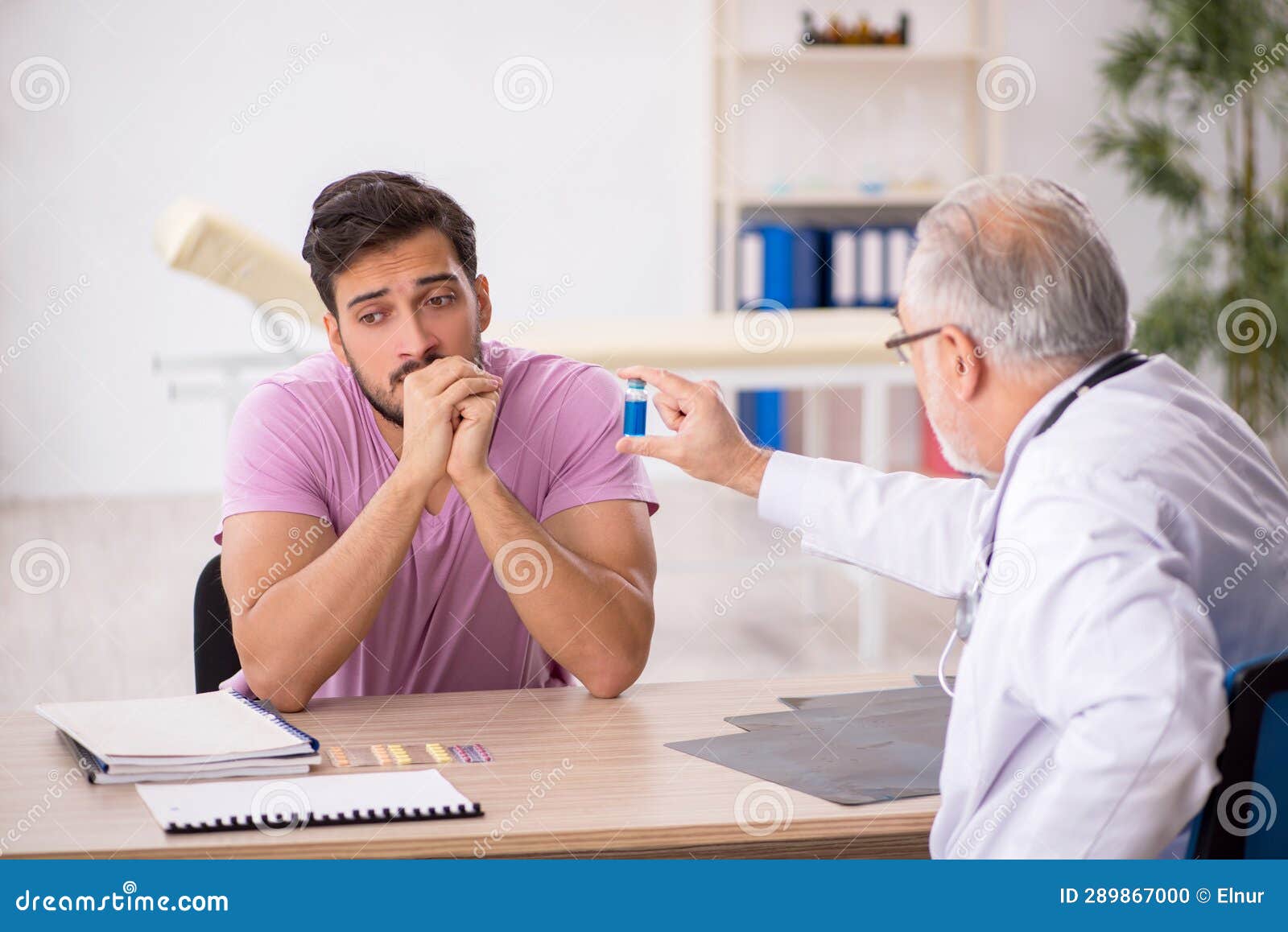 Young Male Patient Visiting Old Male Doctor Stock Photo - Image of ...