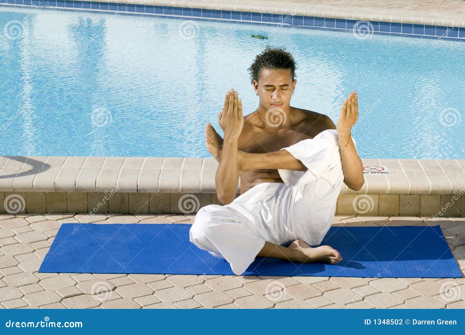 Young male practicing Yoga stock photo. Image of stretches - 1348502