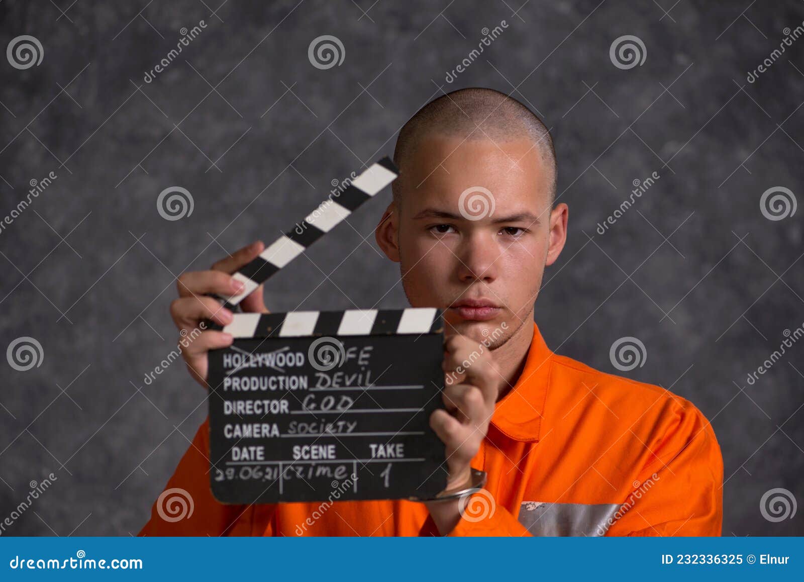 Young Male Prisoner Holding Clapper-board on Grey Stock Image - Image ...