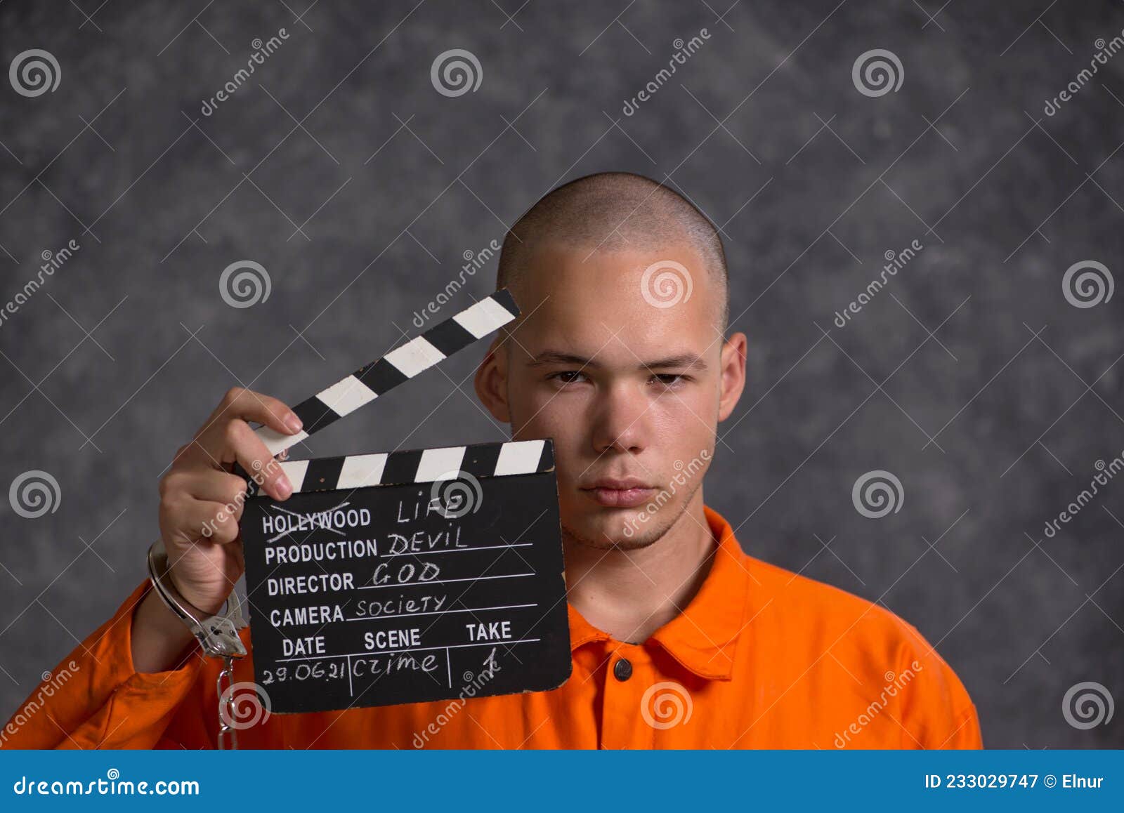 Young Male Prisoner Holding Clapper-board Isolated on Grey Stock Image ...