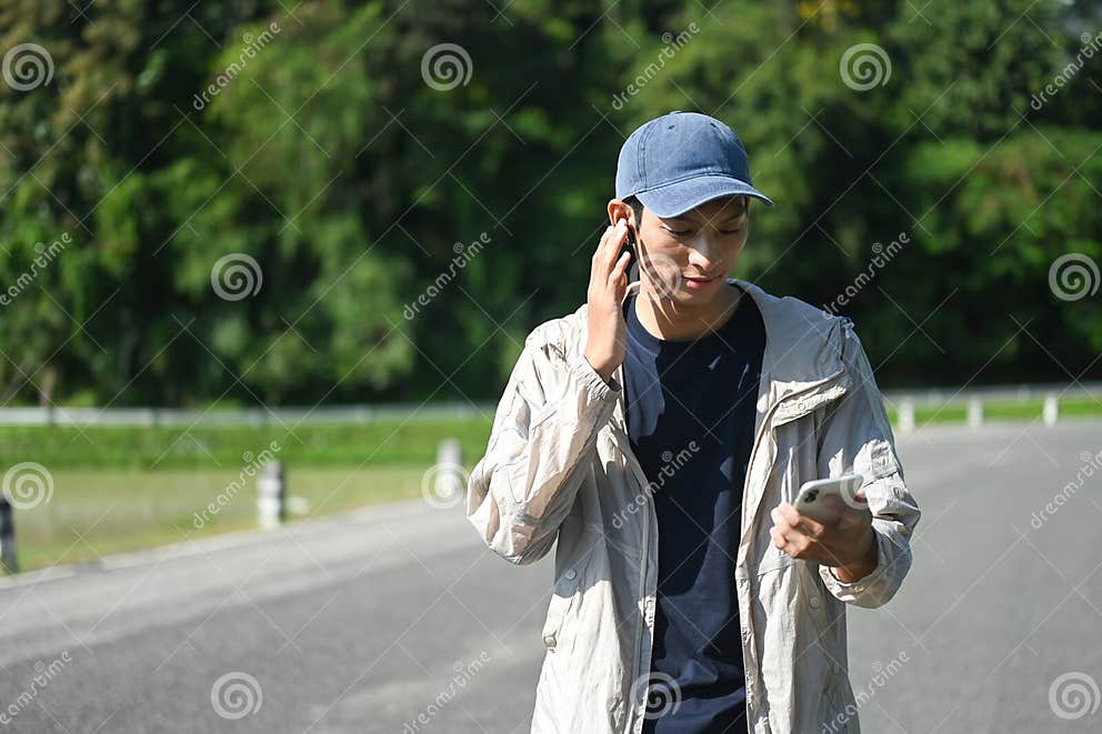Young Male Runner Checking Progress on His Smart Phone Outdoors Stock ...