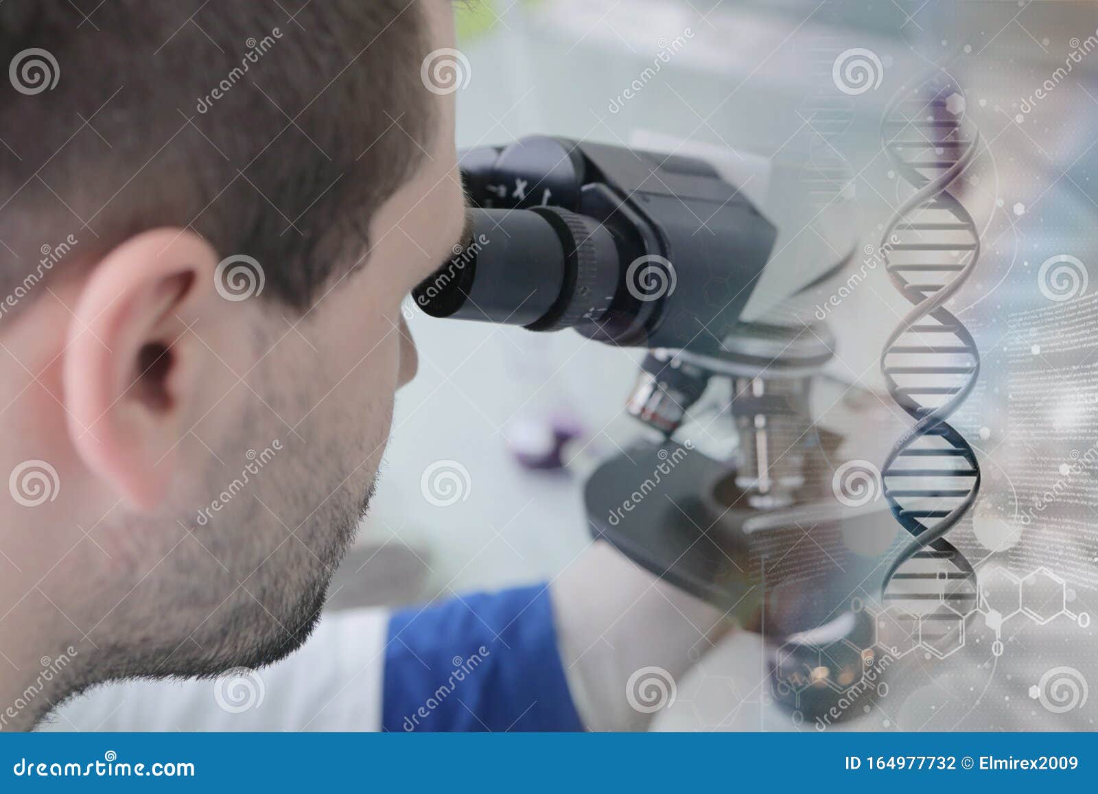 Young Male Male Scientist Looking through a Microscope in a Labo Stock ...