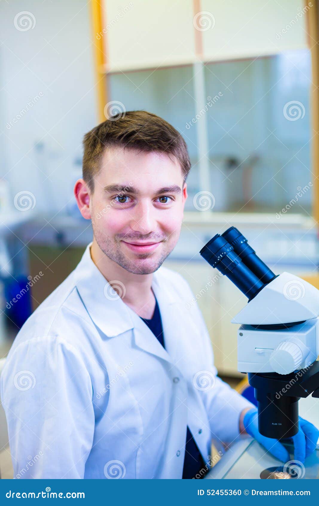 Young Male Scientist with a Microscope Checking His Sample Stock Photo ...