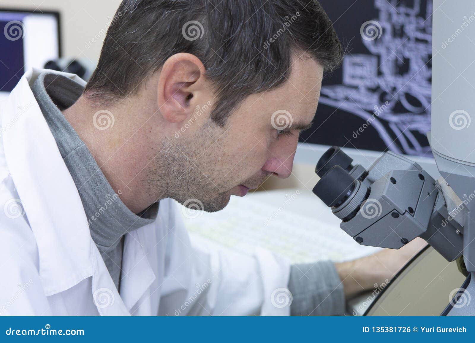 Young Male Scientist Works with a Microscope in a Science Lab Stock ...