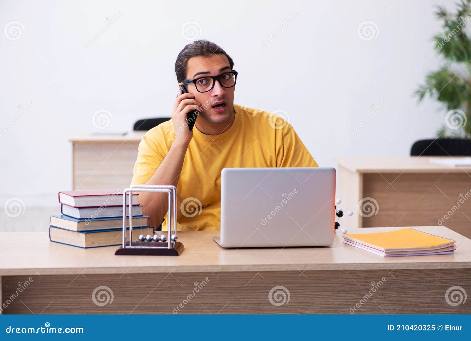 Young Male Student Holding Mobile Phone during Exam Preparation Stock ...